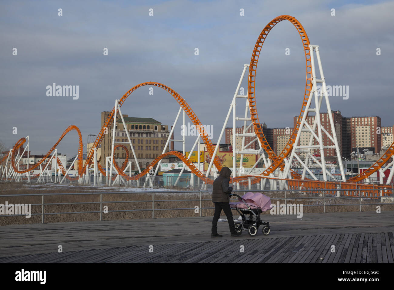 Woman pushes a twins baby stroller along the boardwalk in Coney Island ...
