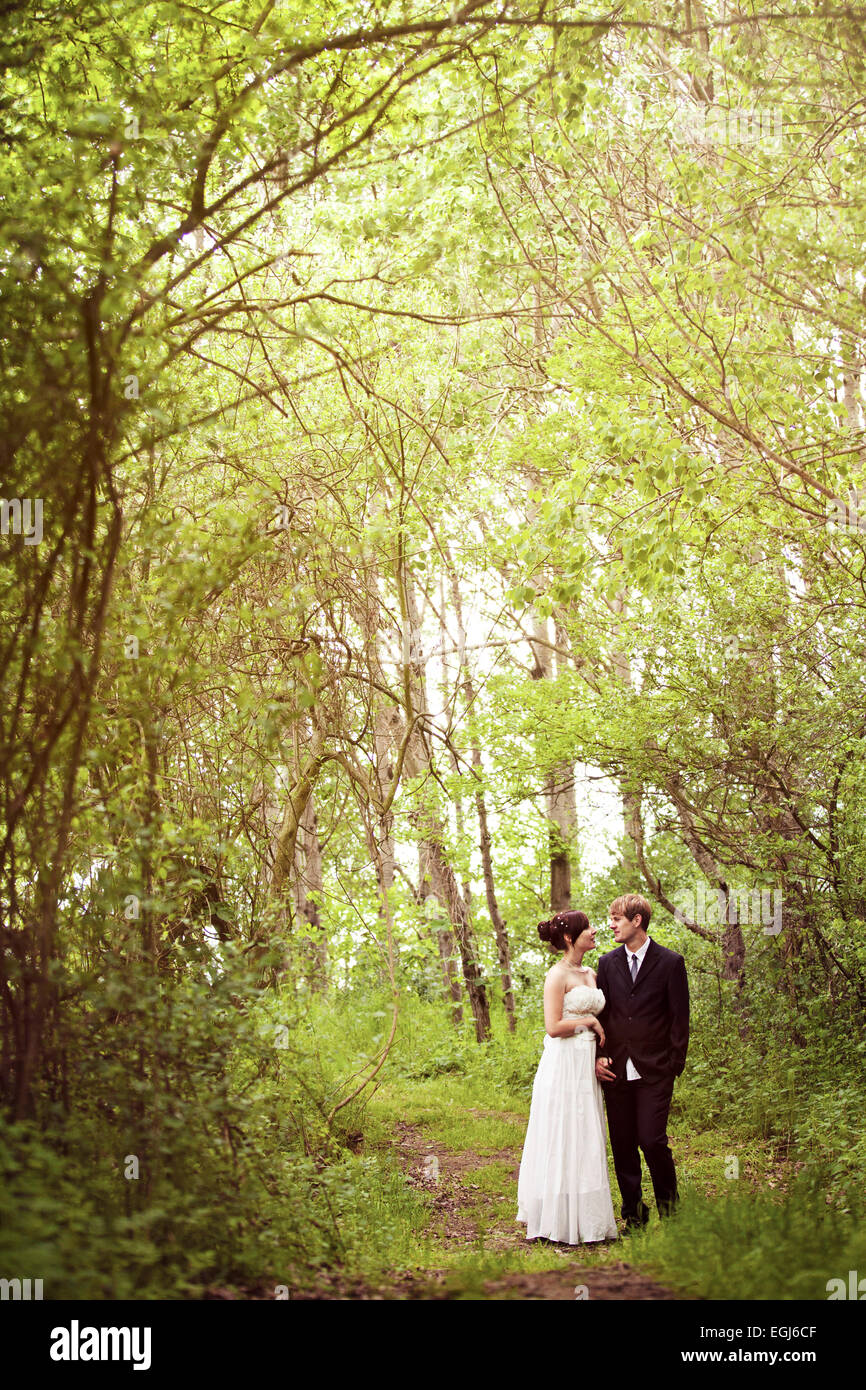 Bridal couple in forest Stock Photo - Alamy