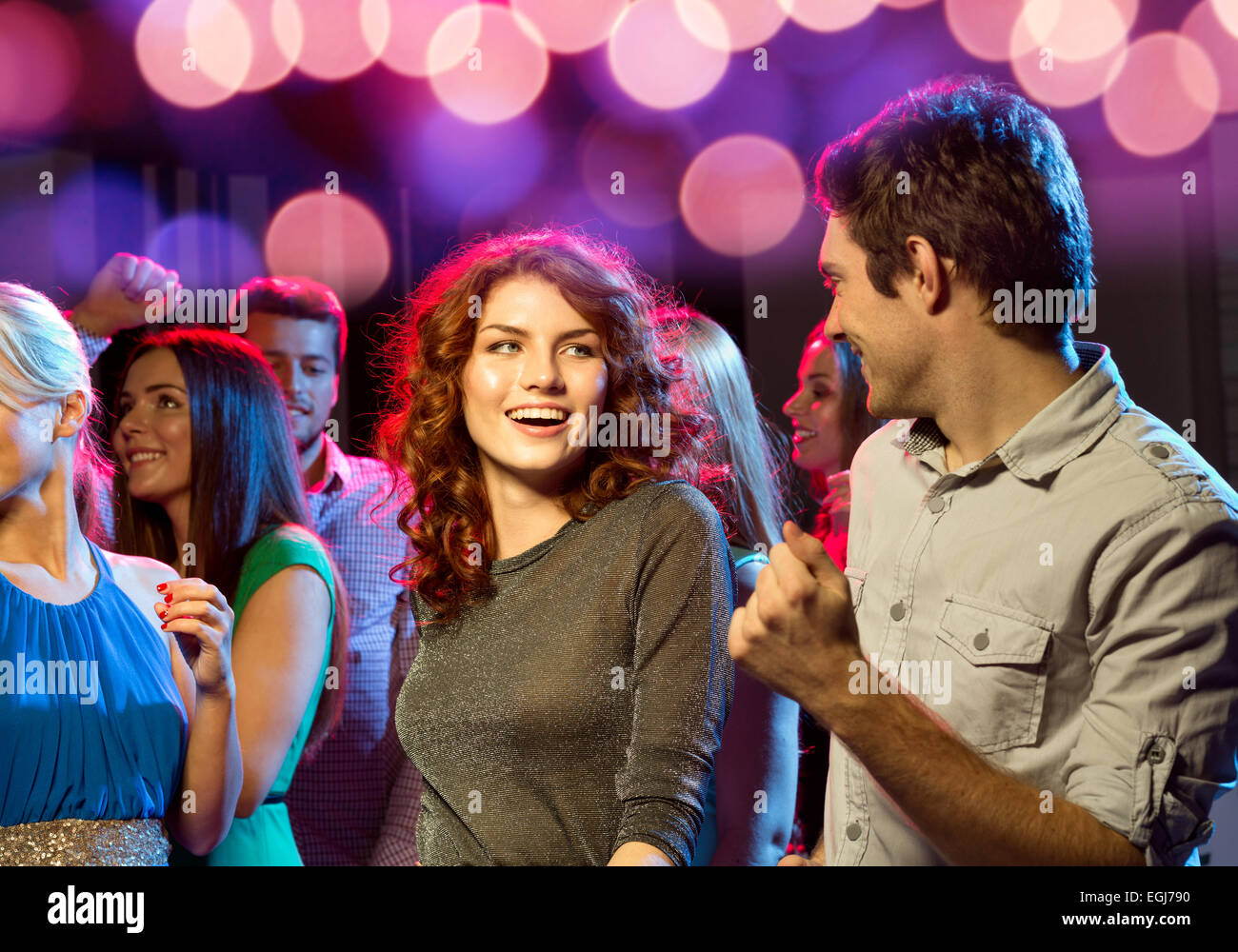 smiling friends dancing in club Stock Photo - Alamy
