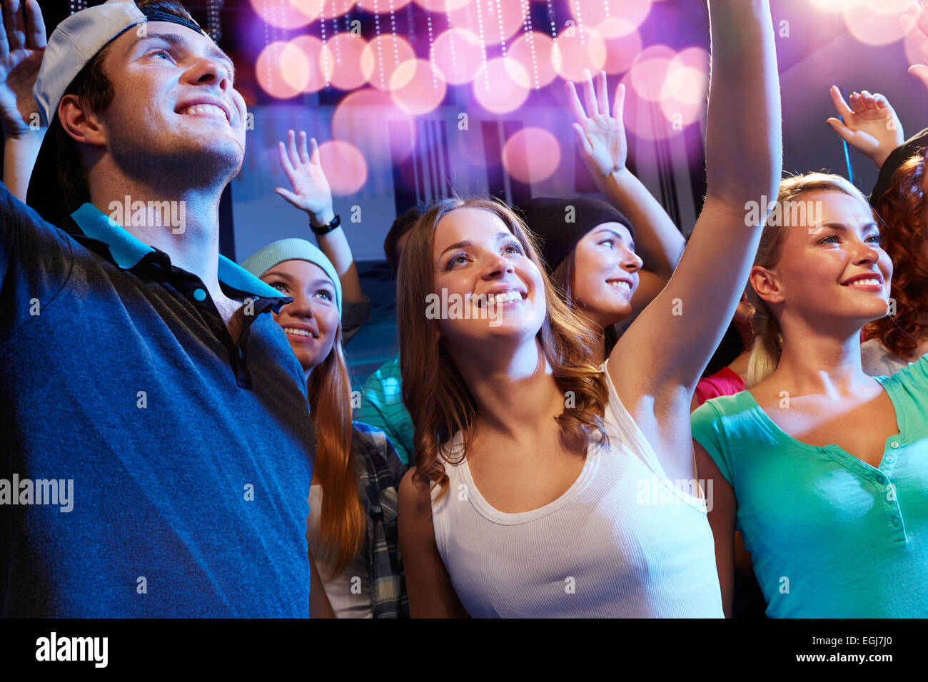 smiling friends at concert in club Stock Photo - Alamy