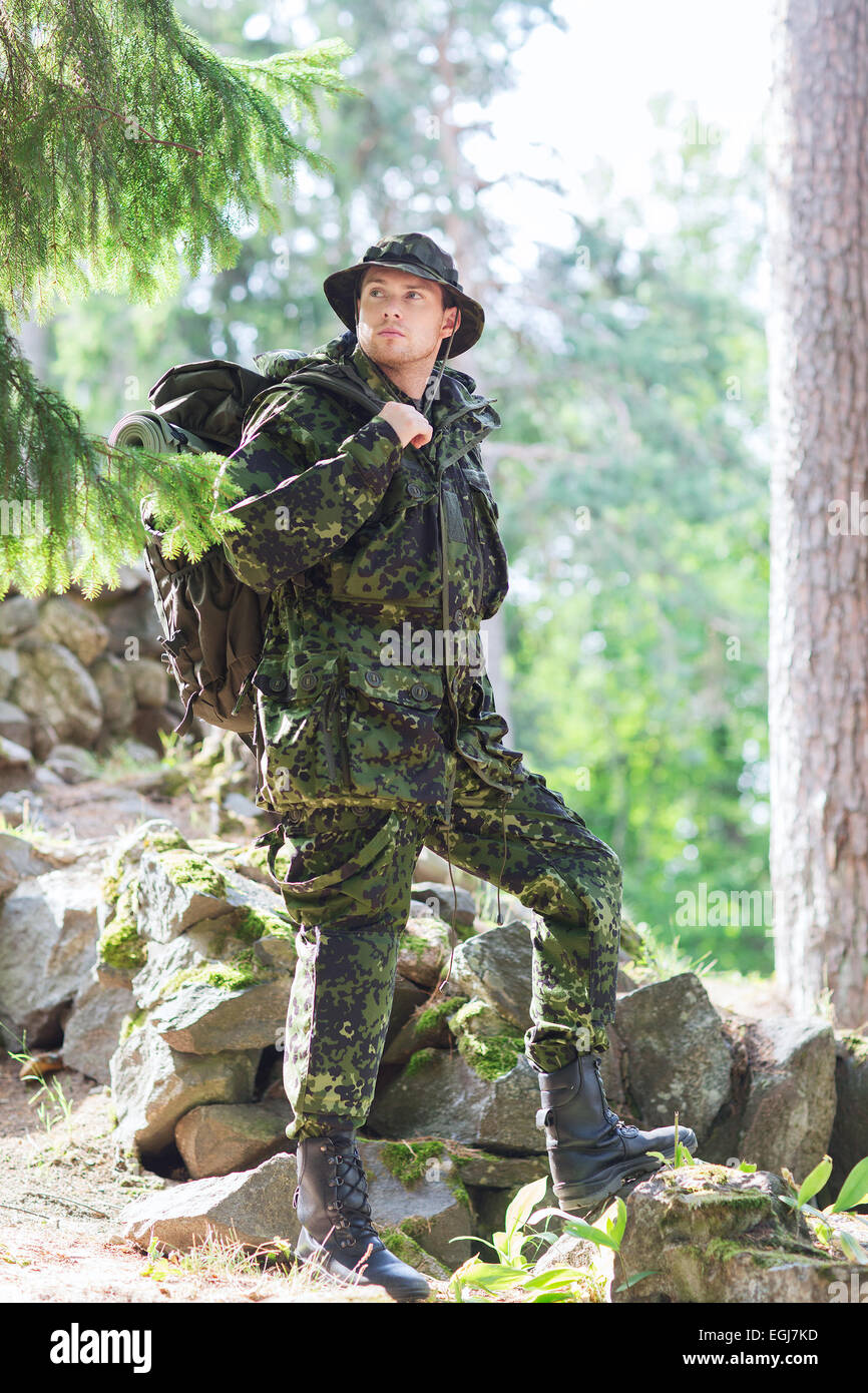 young soldier with backpack in forest Stock Photo - Alamy