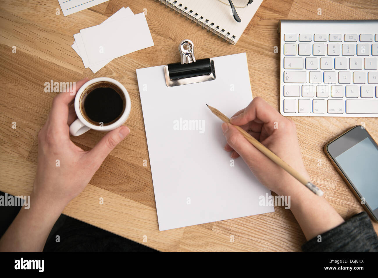 Women working and drinking coffee in her office Stock Photo - Alamy