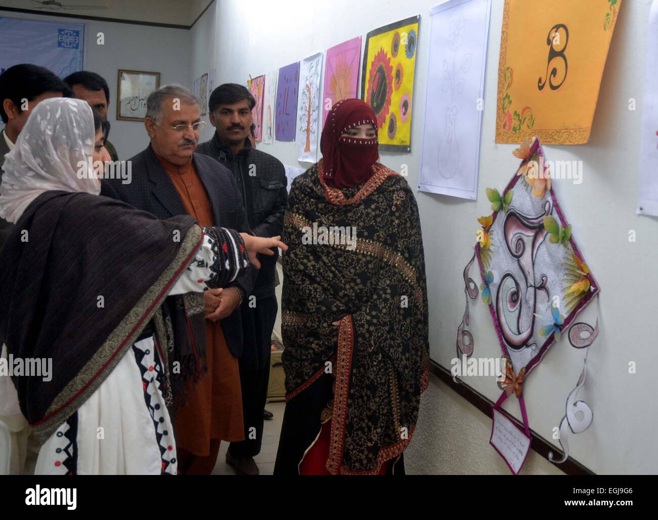 People taking keen interest in watching art works exhibited at a local ...