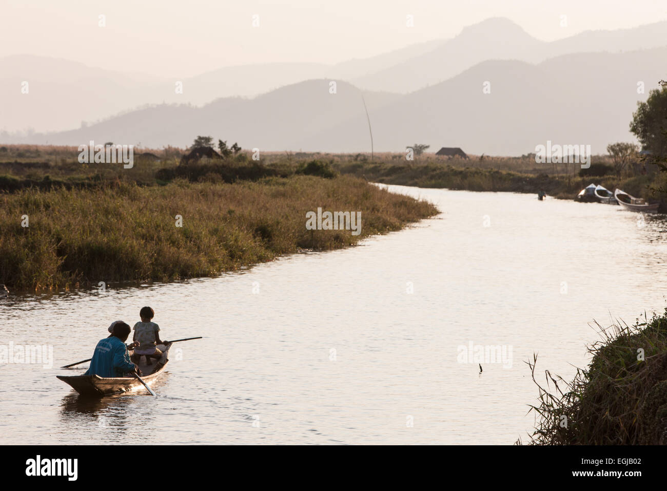 canoe, boat,longboat,long tailed engined boat on waterway canal near ...
