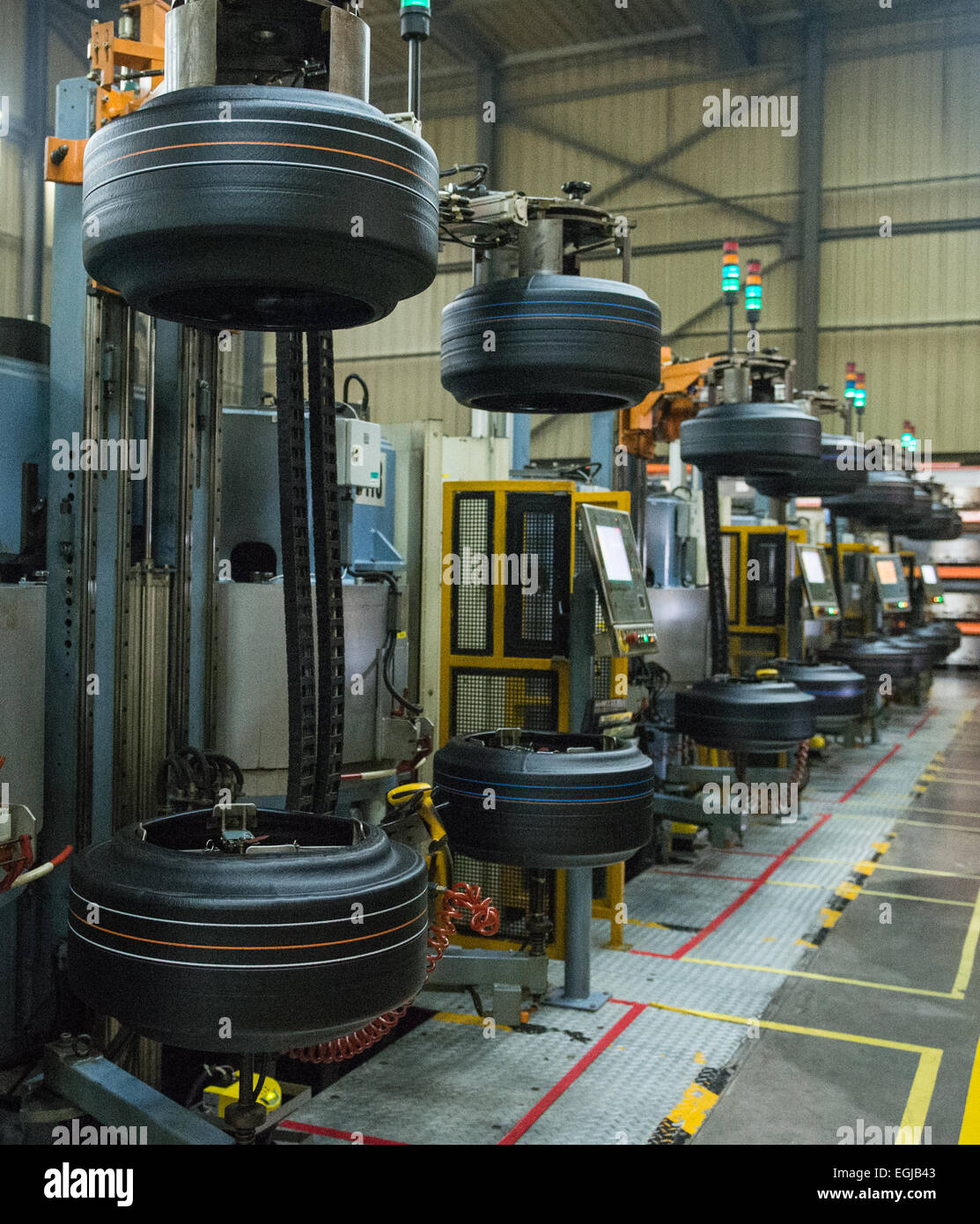 Hefei, China. 12th Nov, 2014. Workpieces lie in a tire press at ...