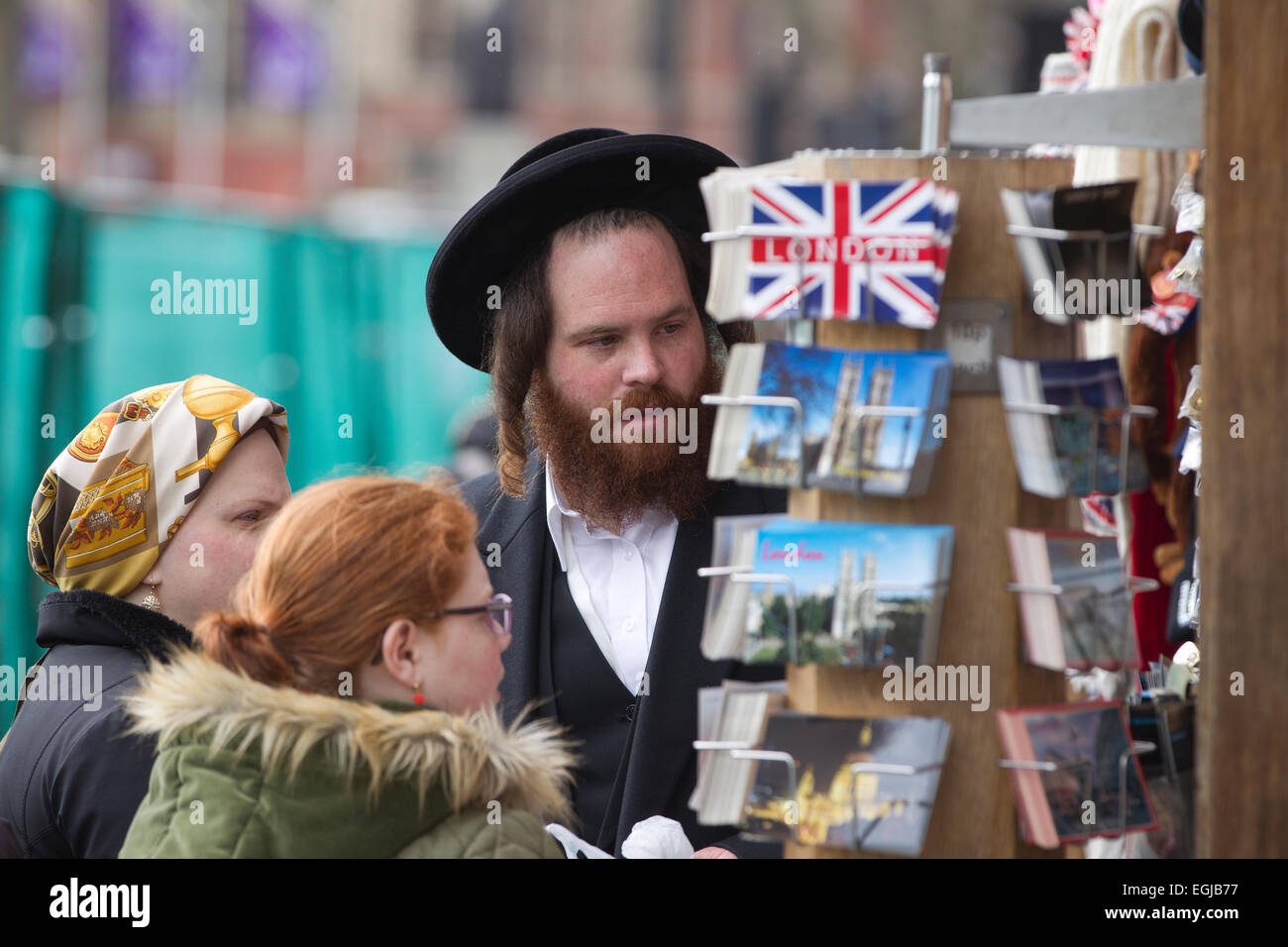Jewish tourists looking at postcards from London at a kiosk in ...