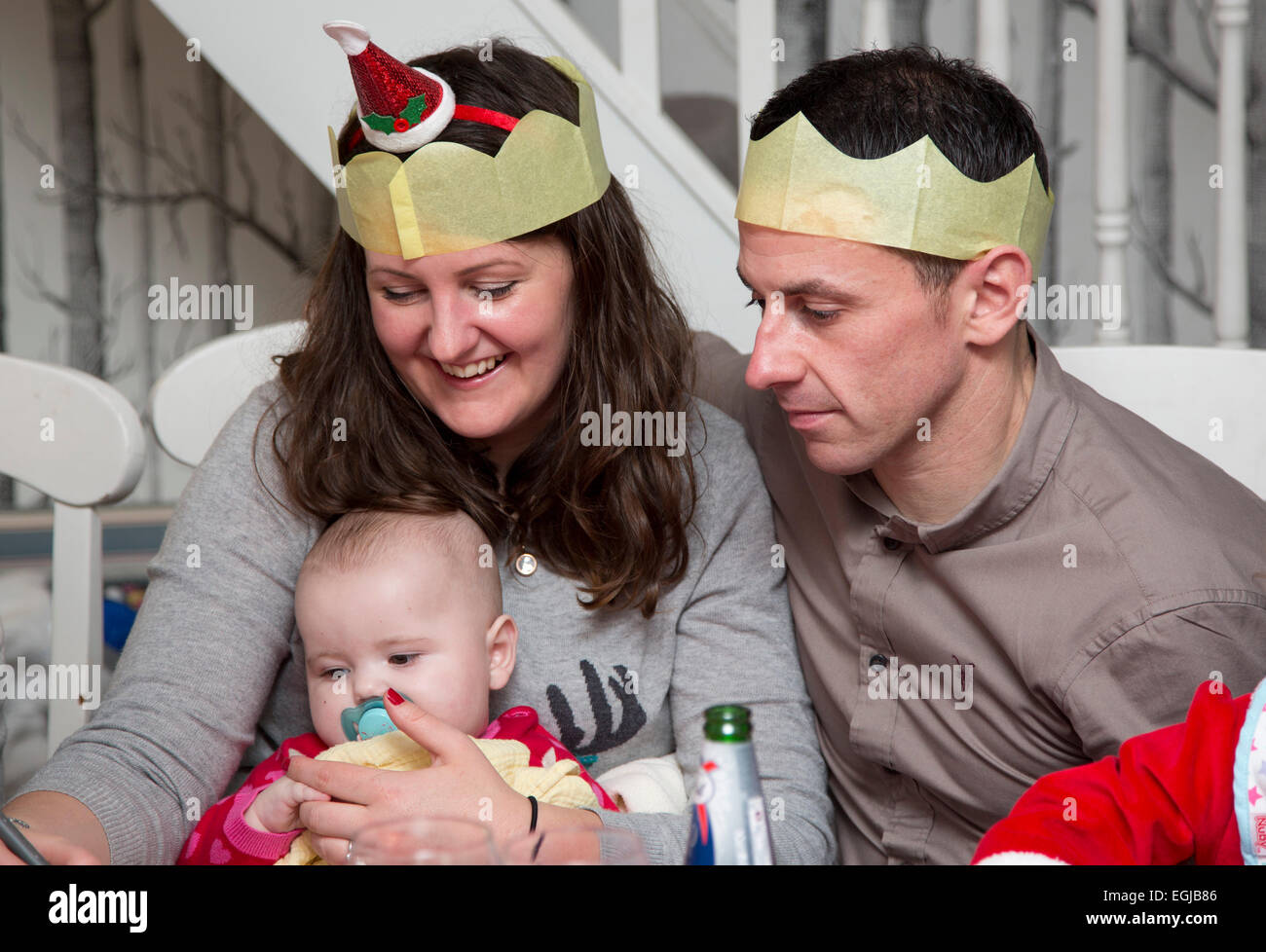 Young couple with their first baby at Christmas Stock Photo - Alamy