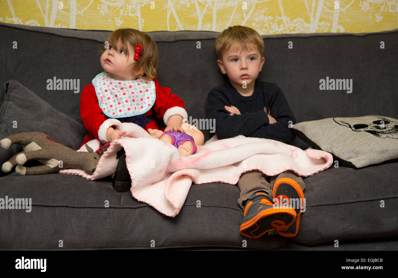 Children sitting on sofa watching TV Stock Photo - Alamy