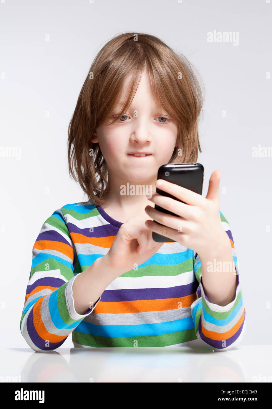 Boy with Blond Hair Reading Text Message on Mobile Phone Stock Photo ...