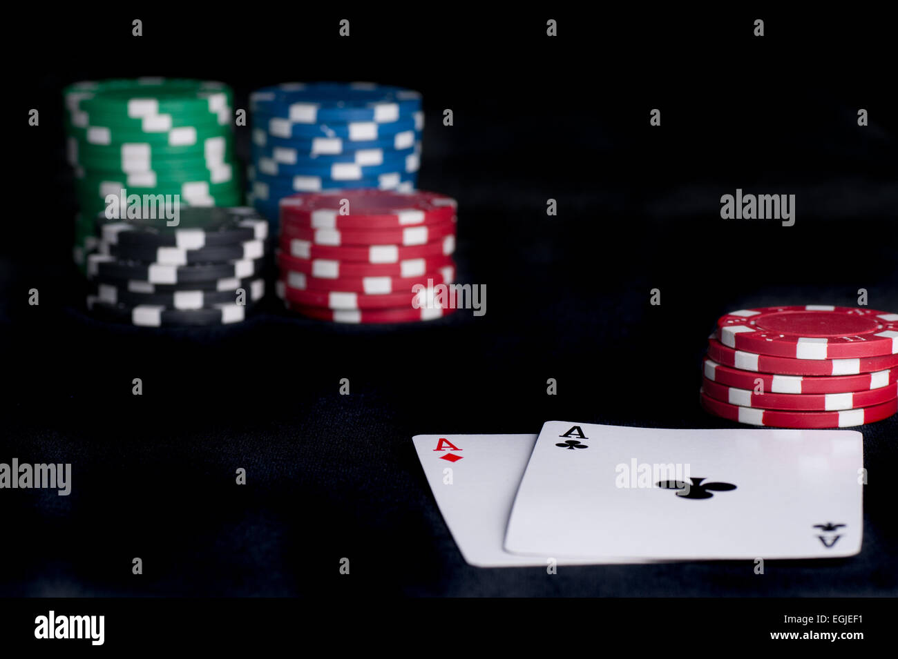 two aces high on black table with chips Stock Photo - Alamy