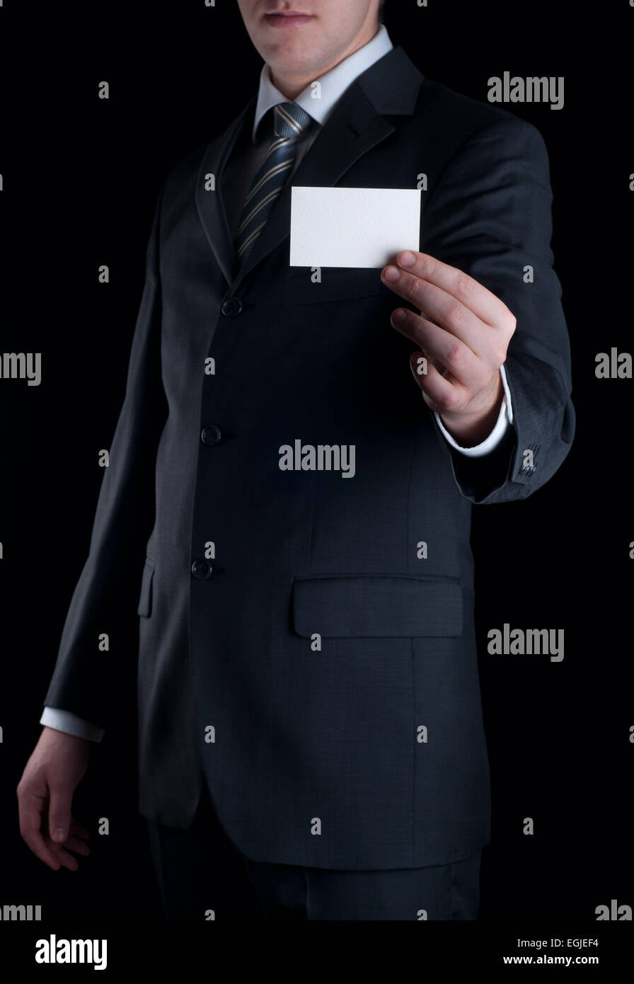 Business man handing a blank business card over black background Stock ...
