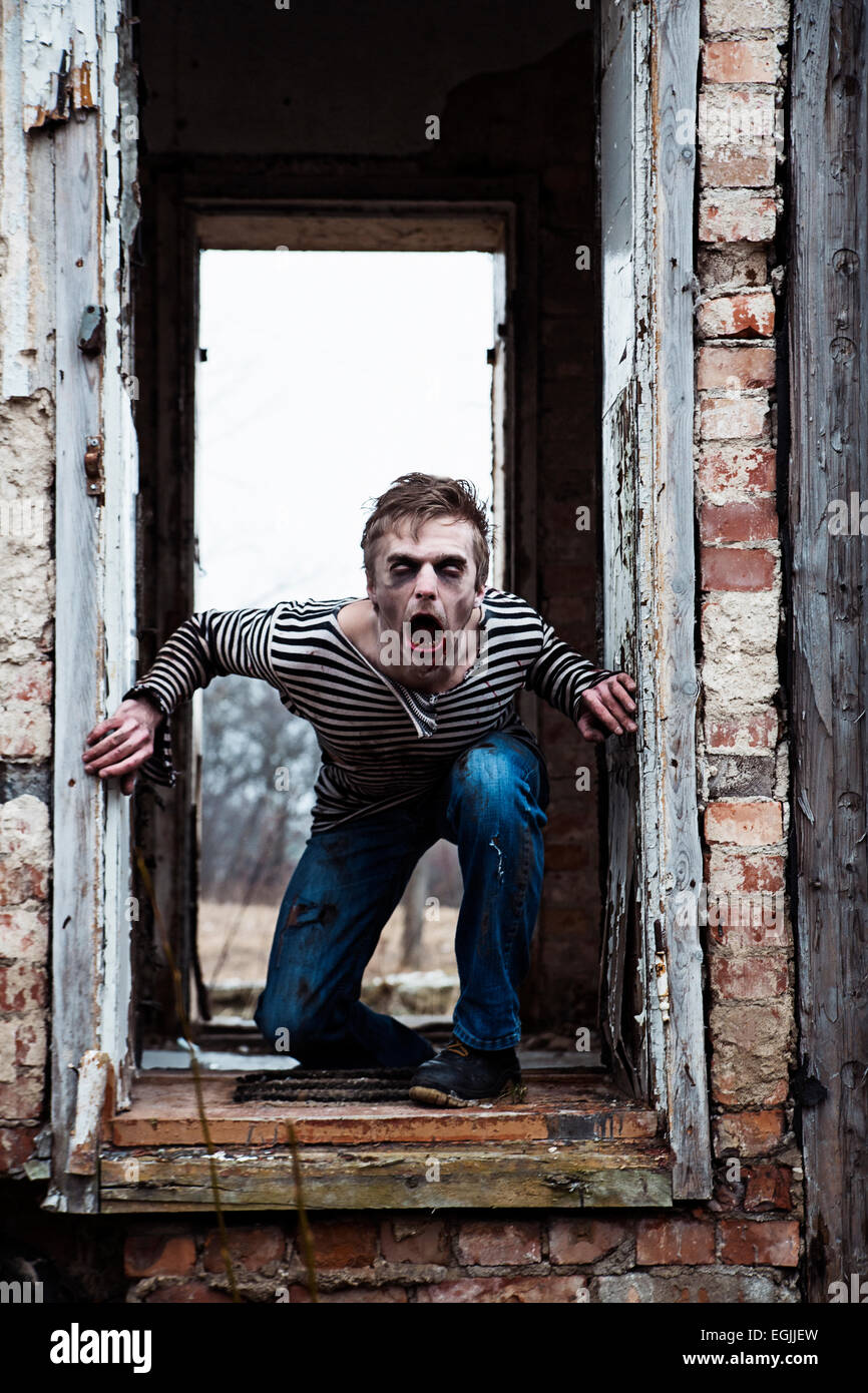 Angry looking zombie is ready to jump Stock Photo - Alamy