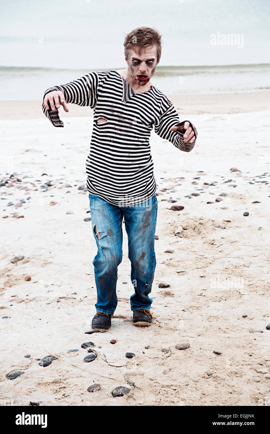 Crawling insane zombie sailor on the seaside Stock Photo - Alamy