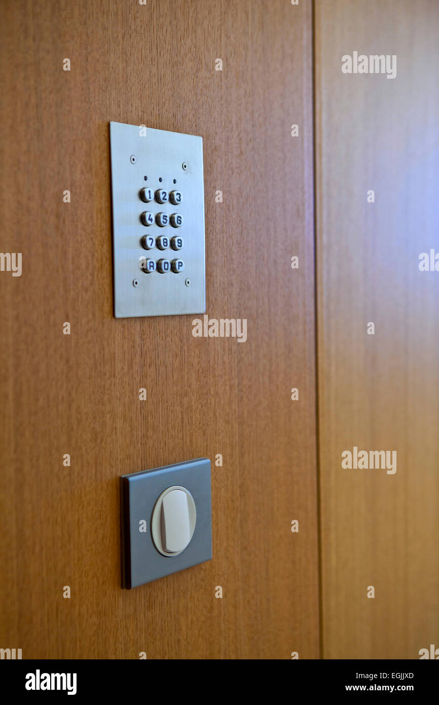 Digital code and switch on a wooden wall inside house Stock Photo - Alamy