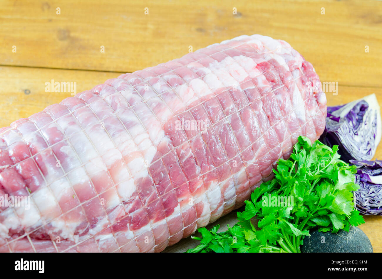 Raw meatloaf on a cutting board, decorated with lettuce and cabbage ...