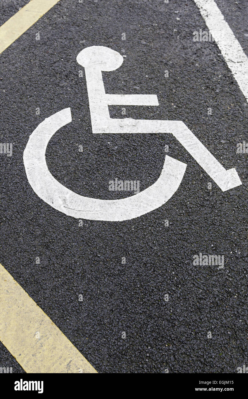 Handicapped sign on asphalt, detail from a diminished signal for people ...