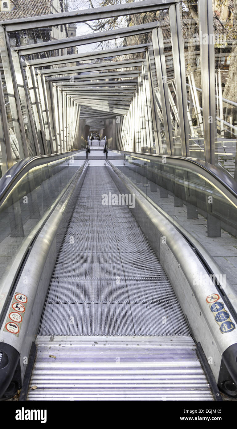 Escalator in the city, detail of stairs to climb a street in the city ...