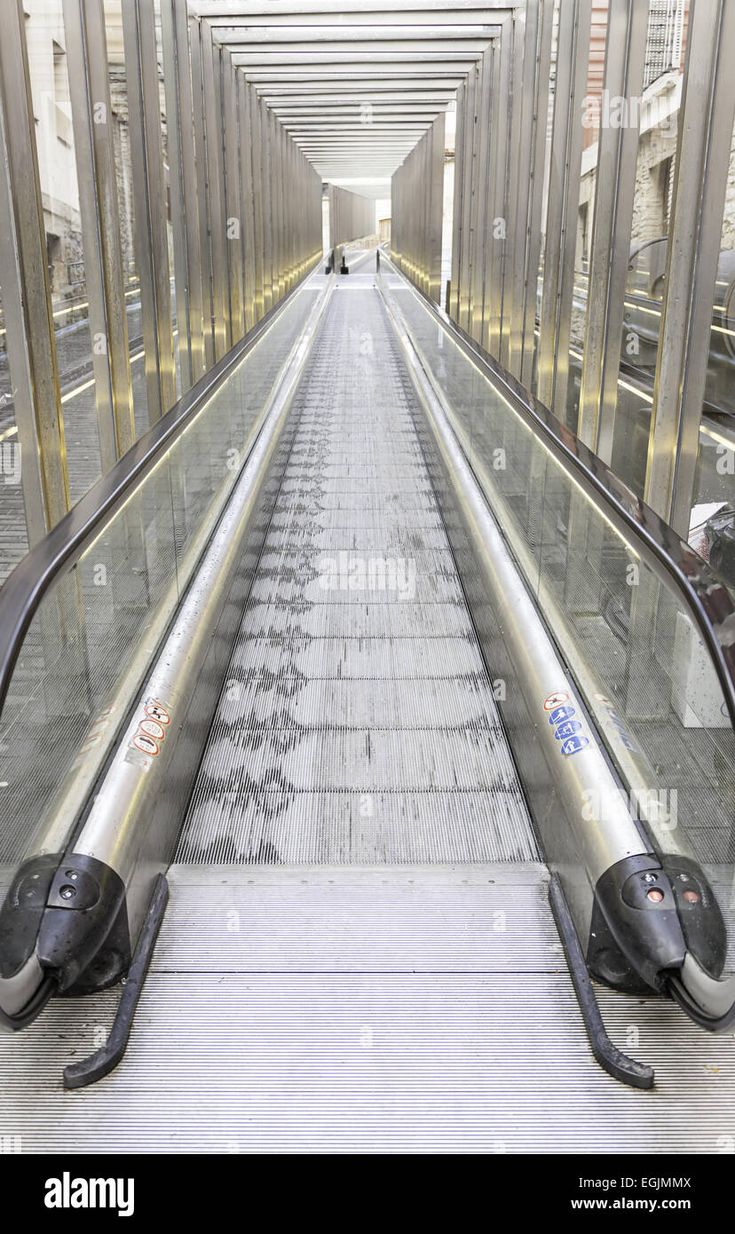 Escalator in the city, detail of stairs to climb a street in the city ...