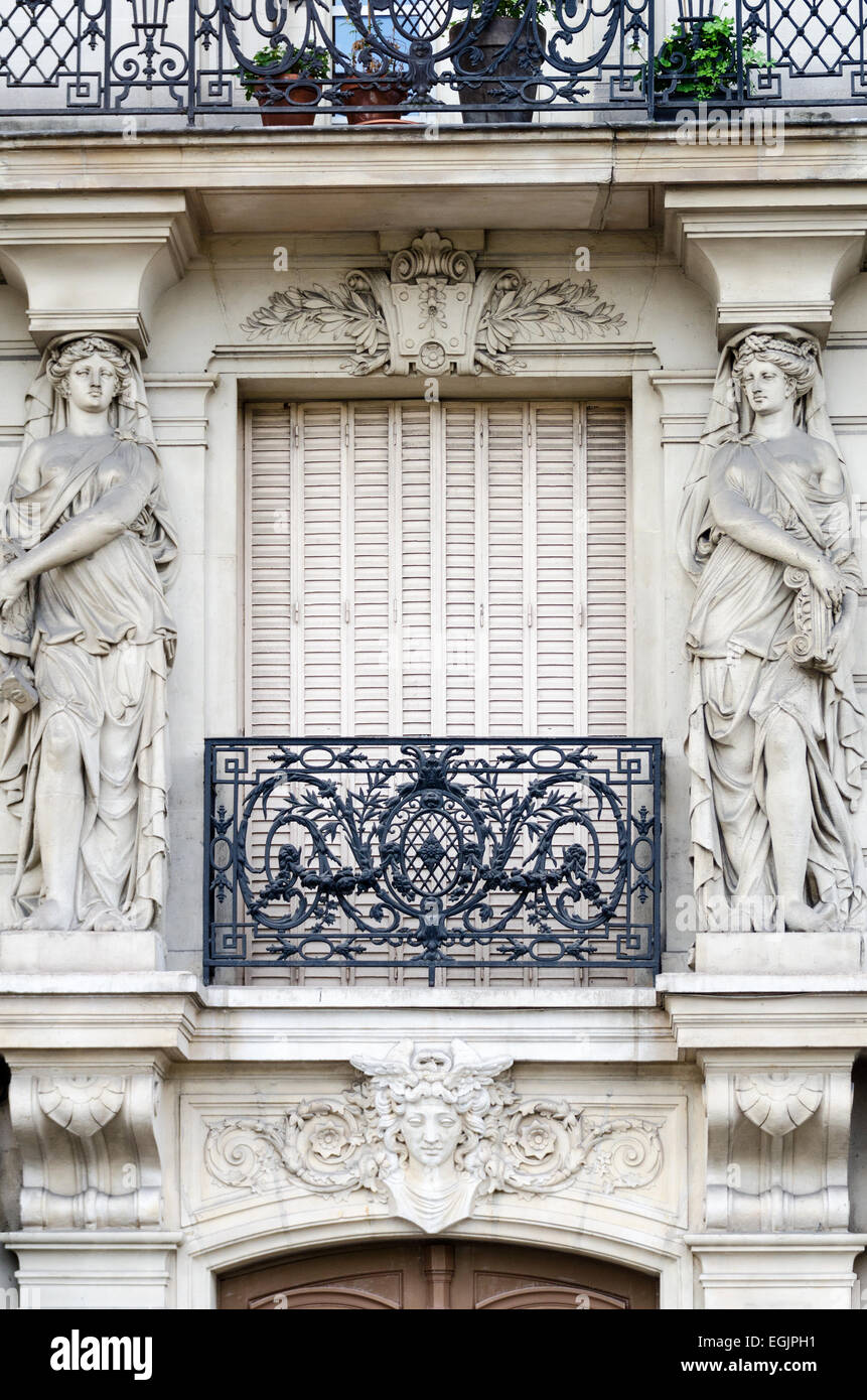 A grand window is flanked by Neoclassical caryatids and ornate wrought ...