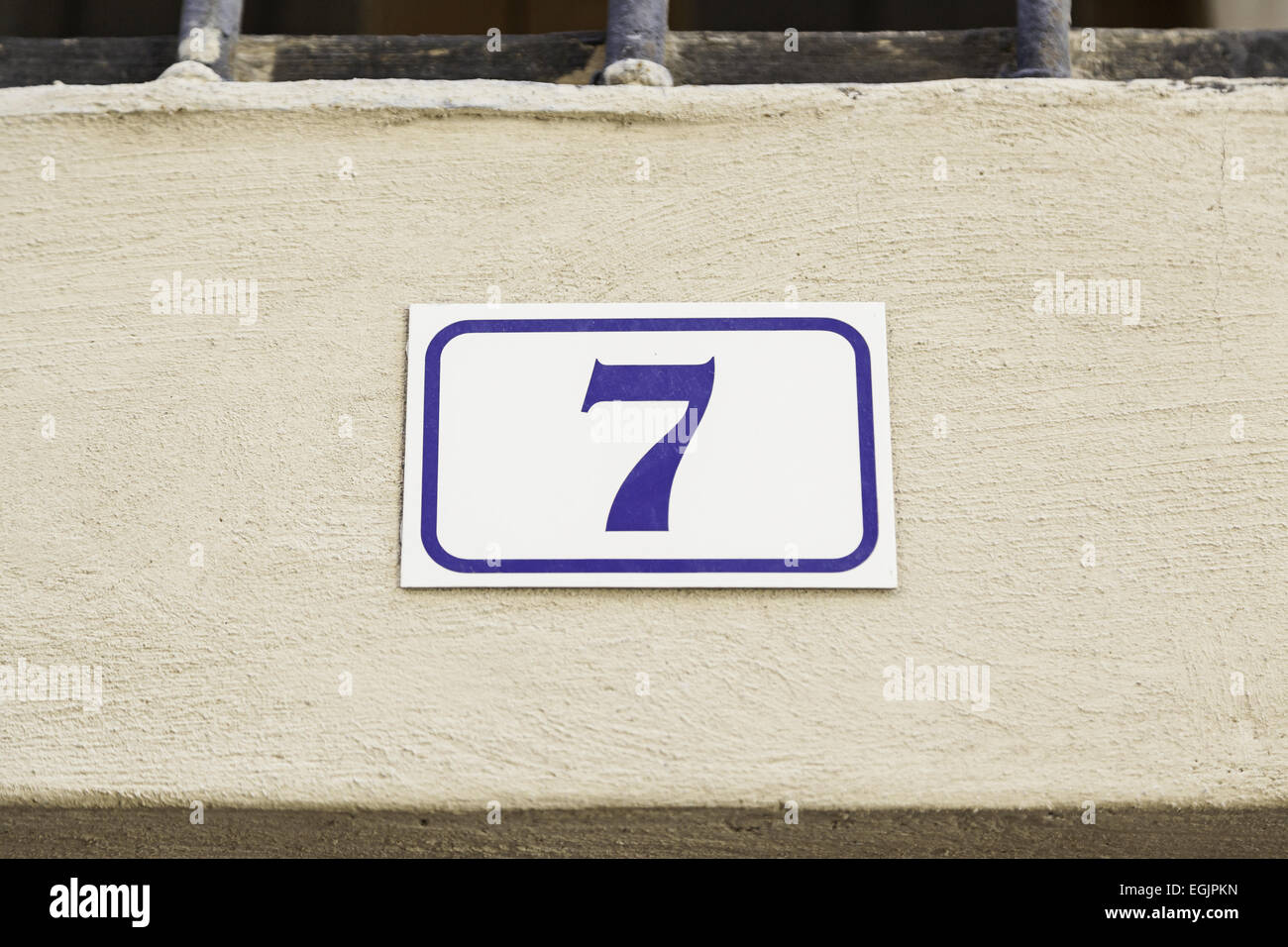 Number seven on a wall, detail of a wall with an information number ...
