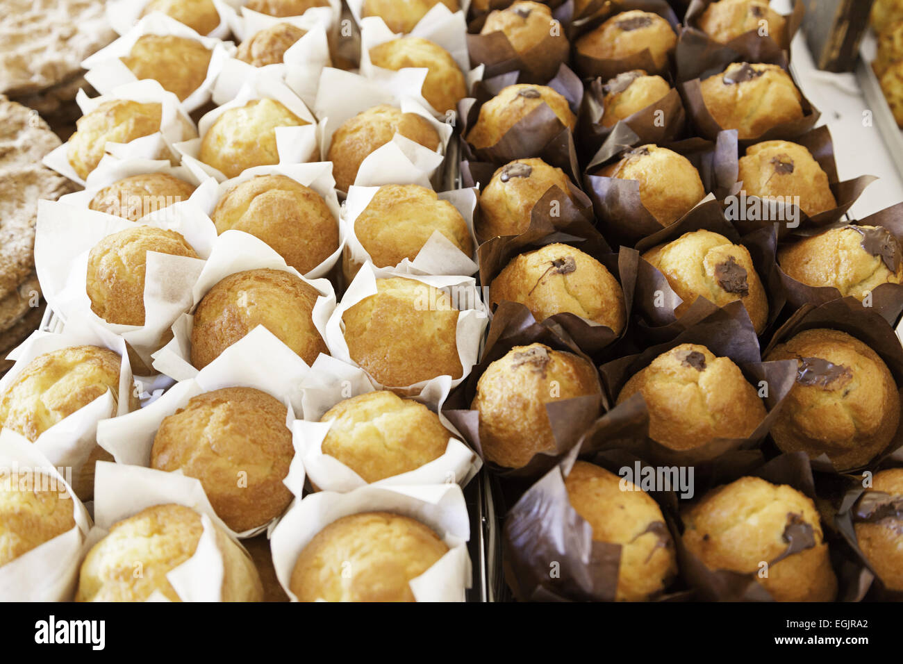 Homemade cupcakes in a market, detail of normal muffins and chocolate ...