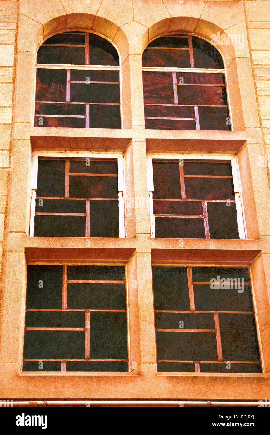 Vertical row of stained glass windows. Red tint and grain filter ...