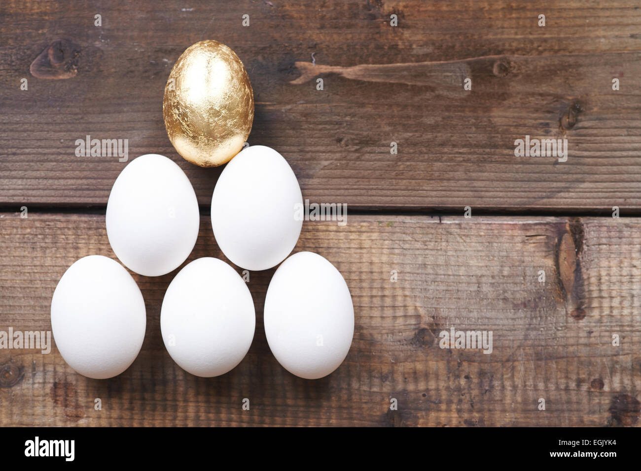 Pyramid made up of eggs with golden one on its top Stock Photo - Alamy