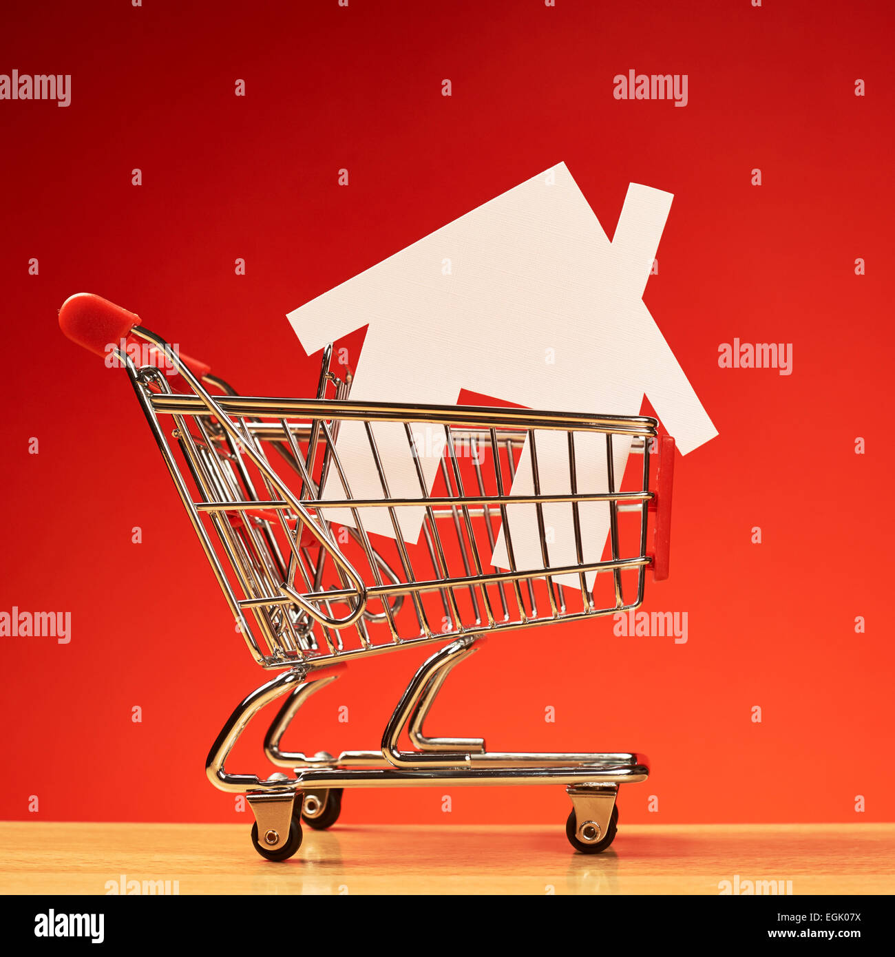 House shape inside shopping cart Stock Photo - Alamy