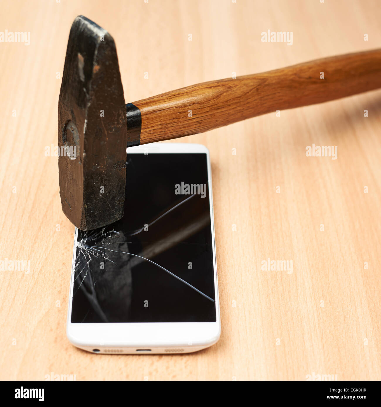 Composition of hammer and a broken phone Stock Photo - Alamy