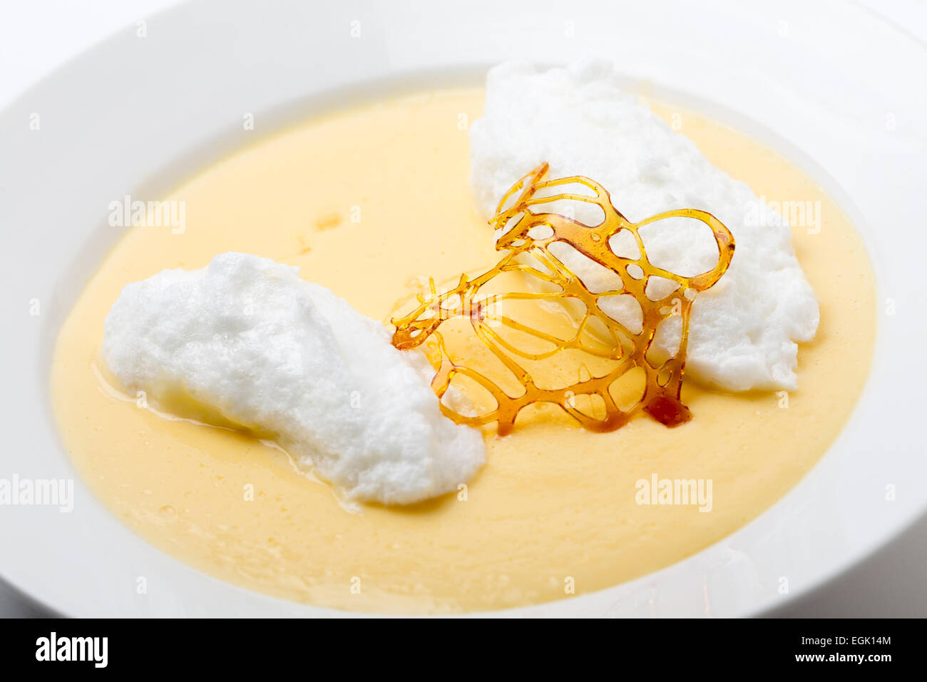 Floating islands, fluffy poached meringue on a lake of custard made ...