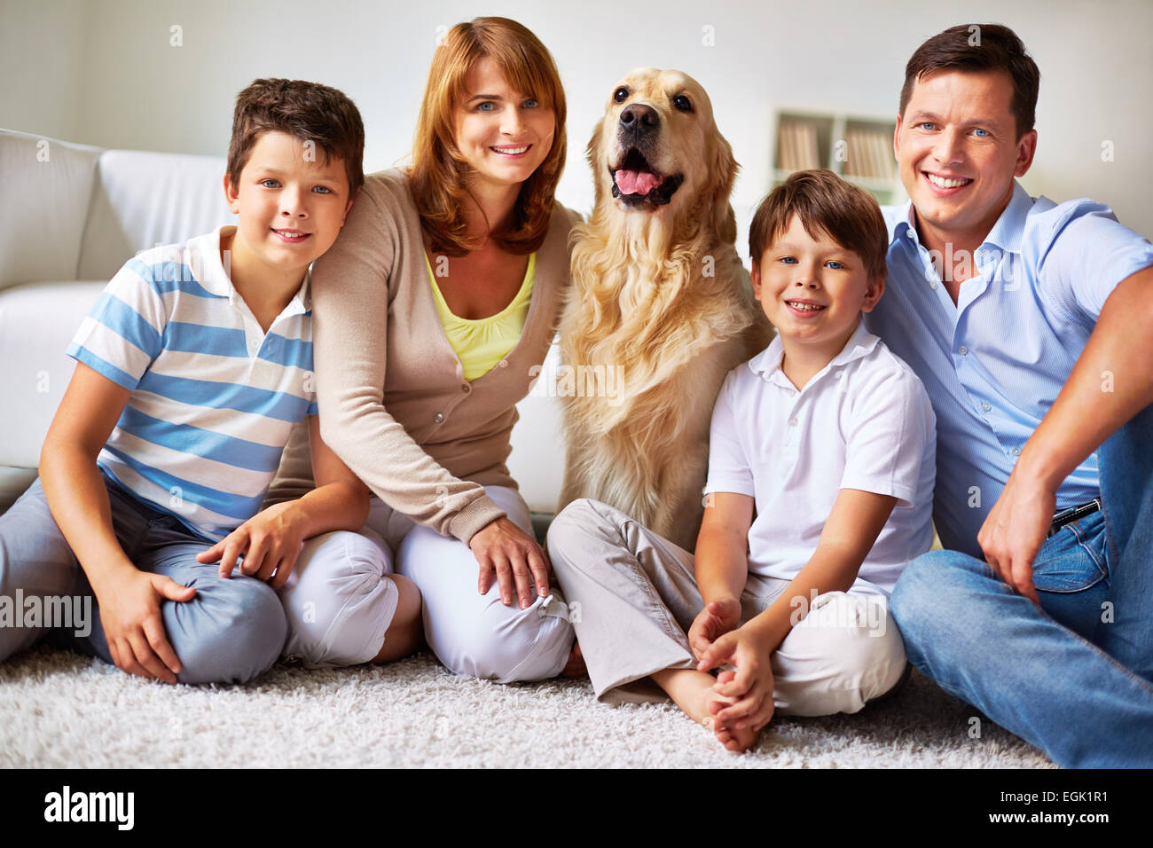Happy young parents, their children and pet Stock Photo - Alamy