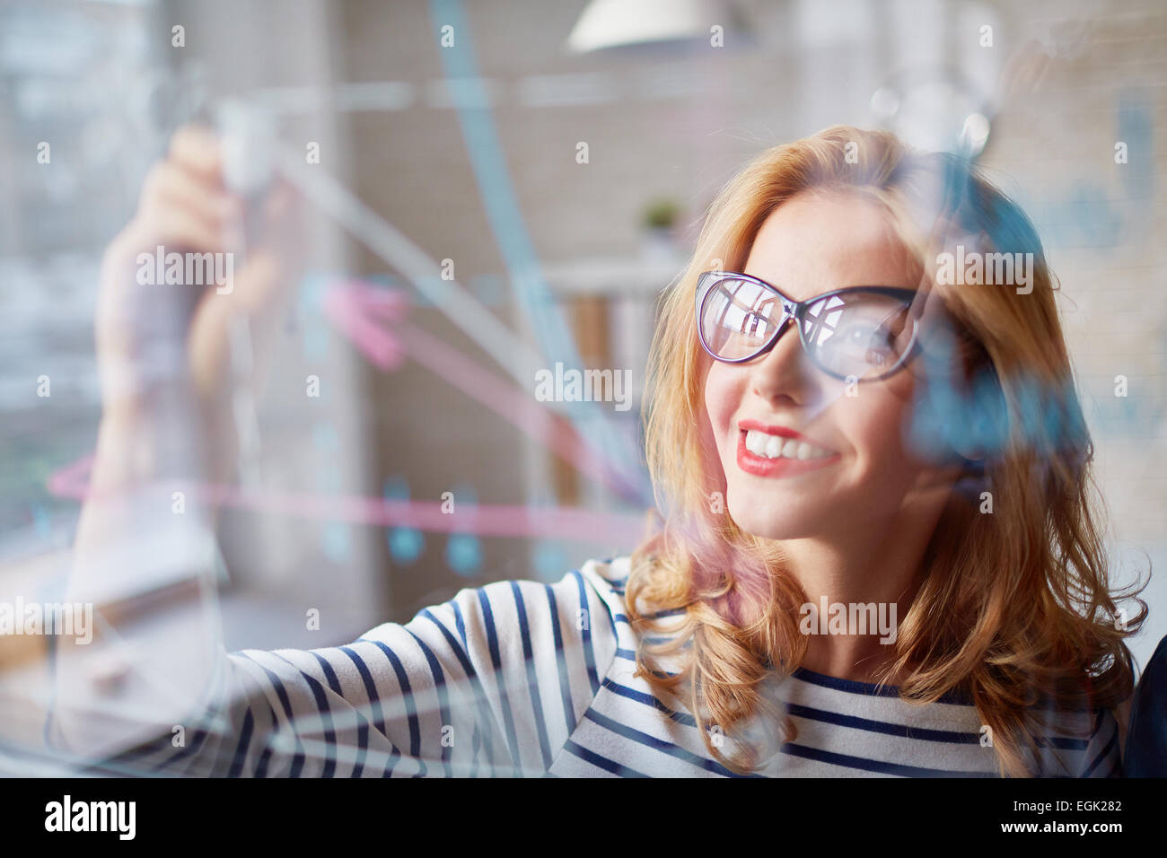 Attractive young businesswoman by transparent board Stock Photo - Alamy
