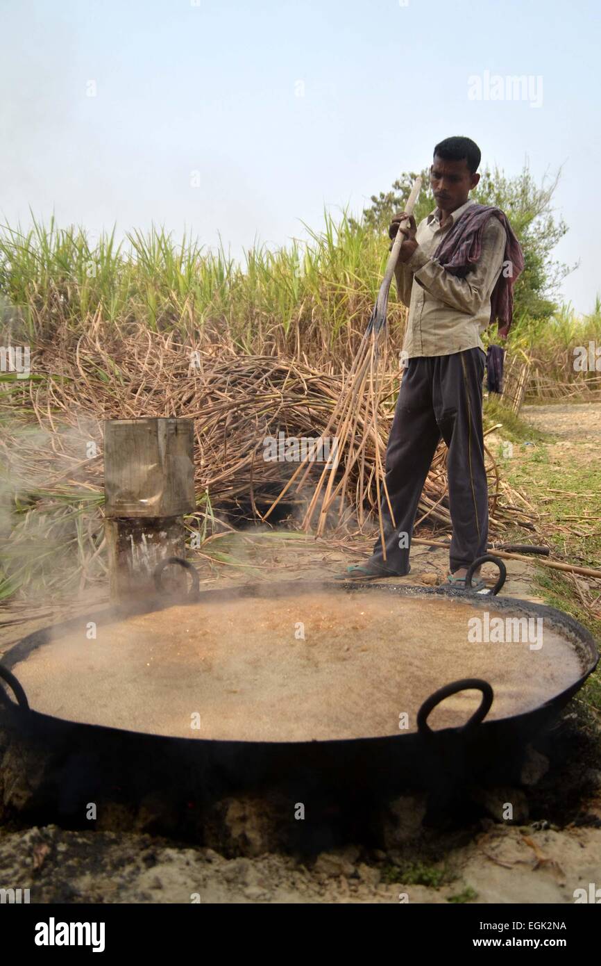 Indian worker boils sugarcane juice to make jaggery, a traditional non ...