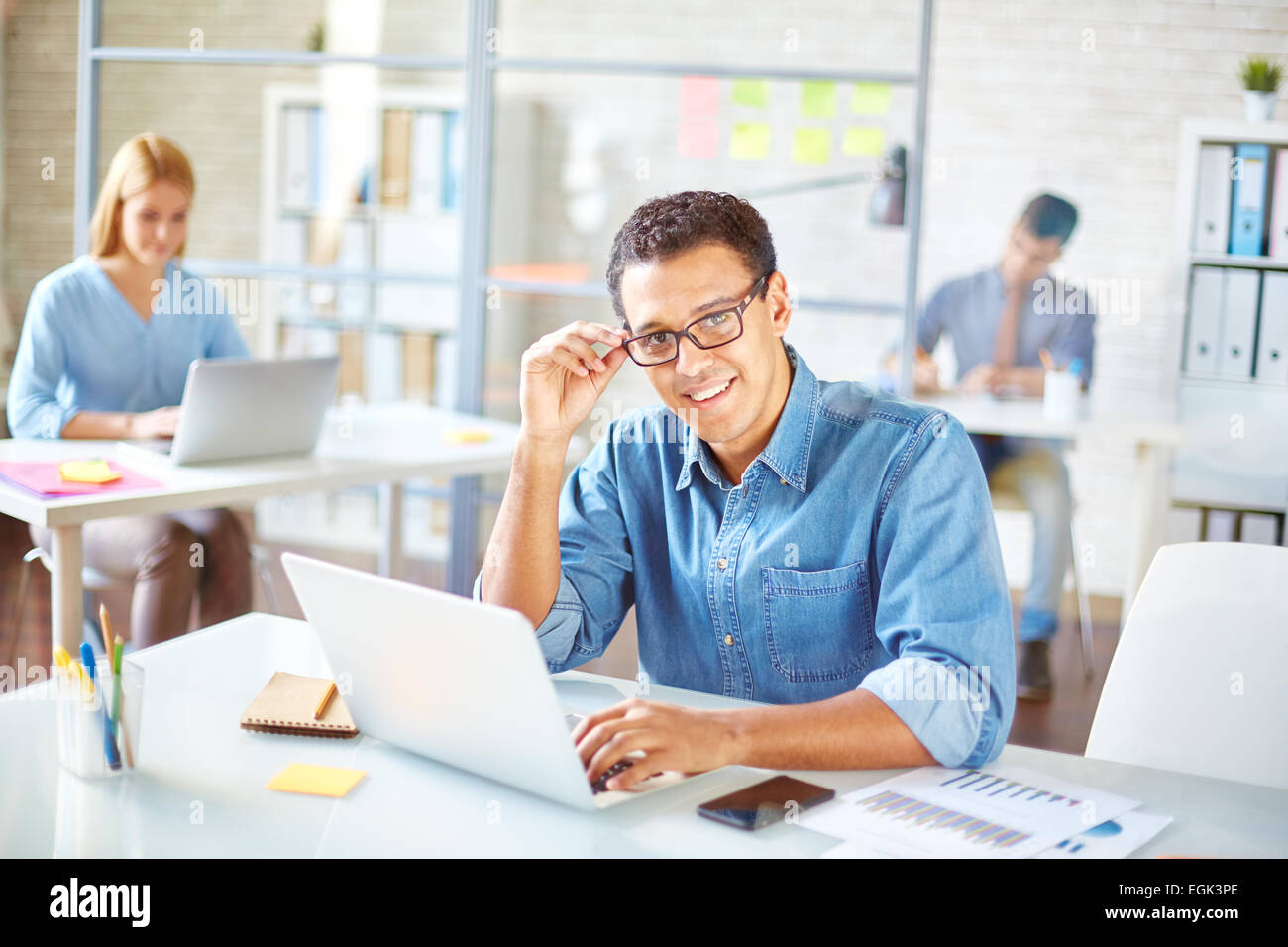 Businessman at workplace looking at camera in working environment Stock ...