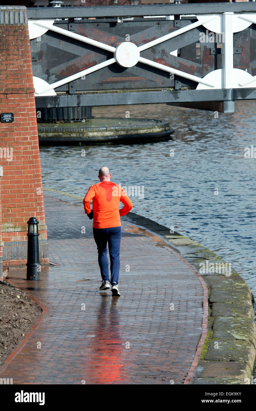Man running on canal towpath, Birmingham city centre, UK Stock Photo ...