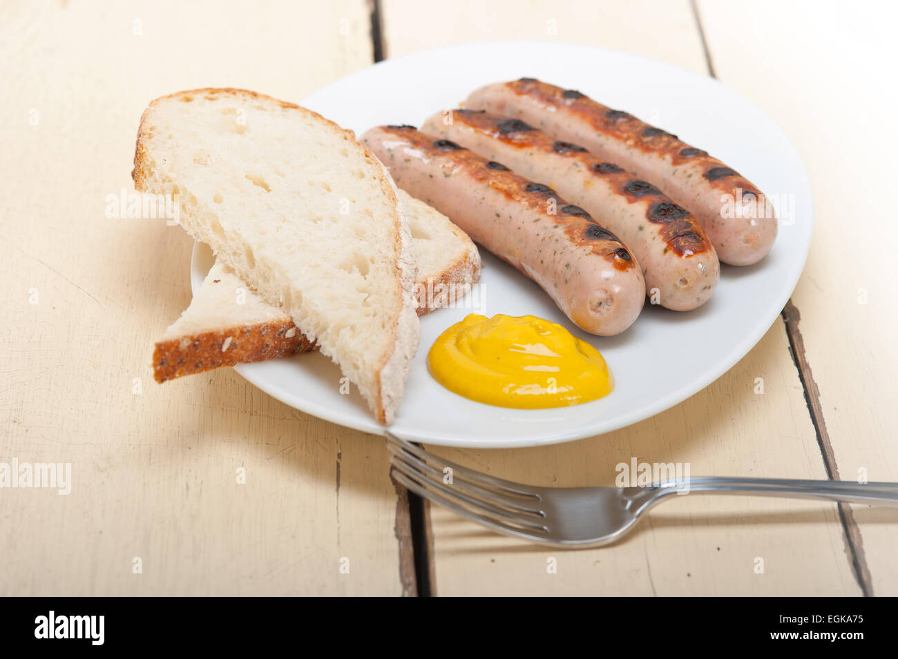 traditional fresh German wurstel sausages grilled with yellow mustard ...
