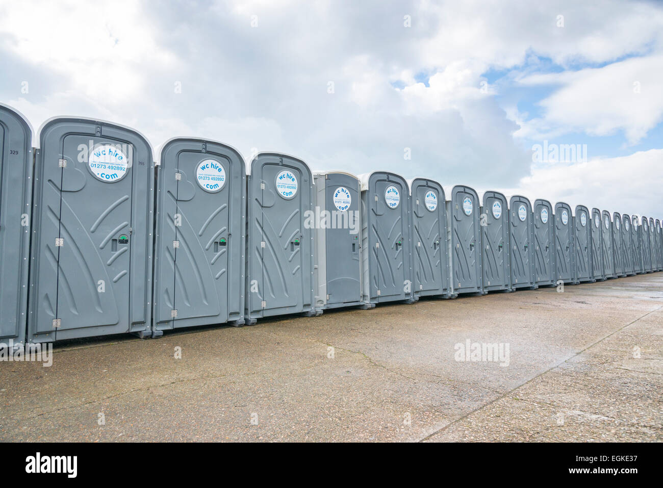 Mobile public toilets lined up at an event in the UK. Hired toilets ...