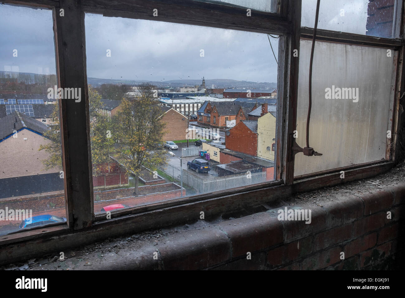 Looking out through a dirty factory window with rain drops on the glass ...