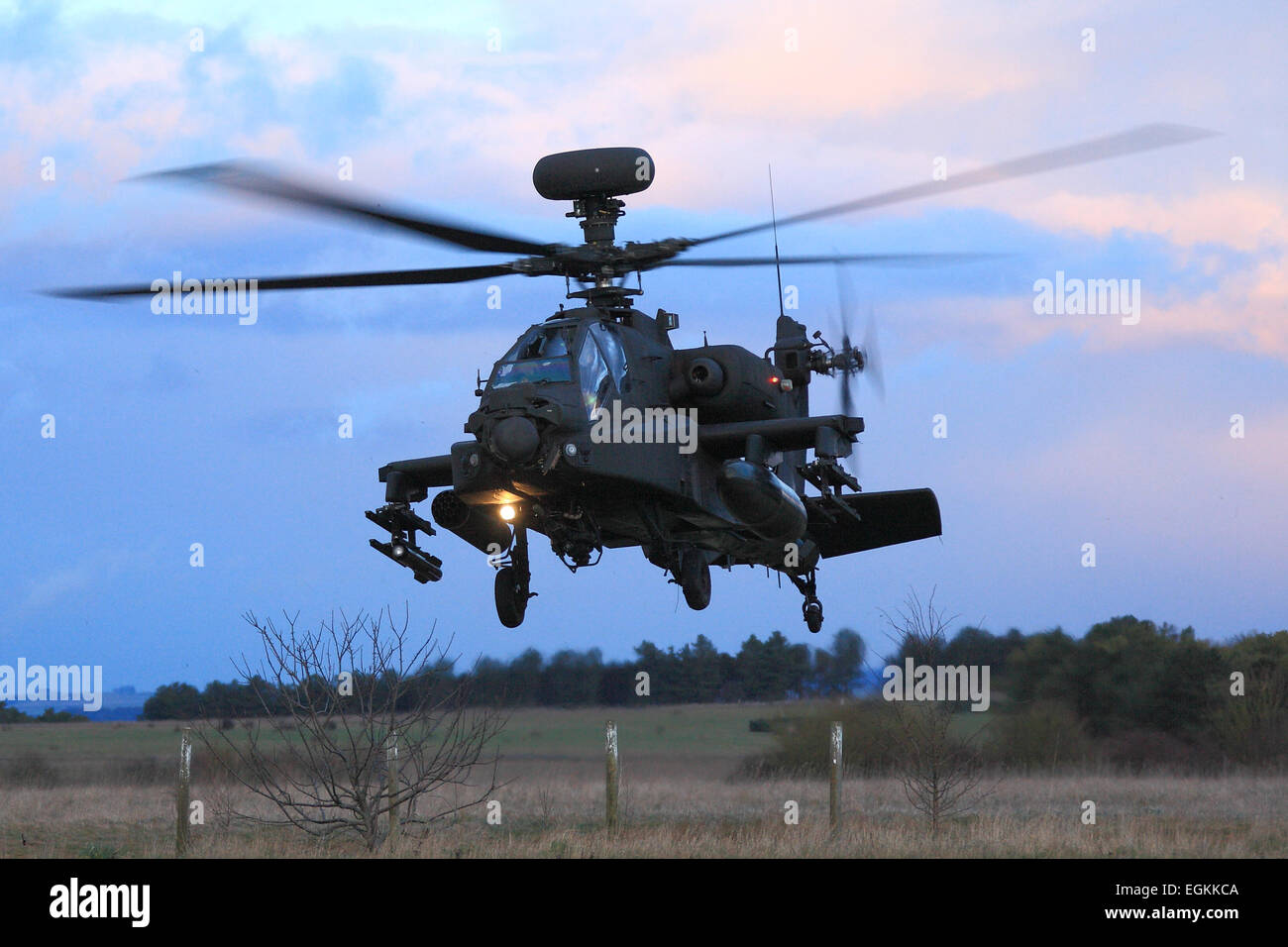British Army Apache AH1 attack helicopter prepares to land at dusk ...