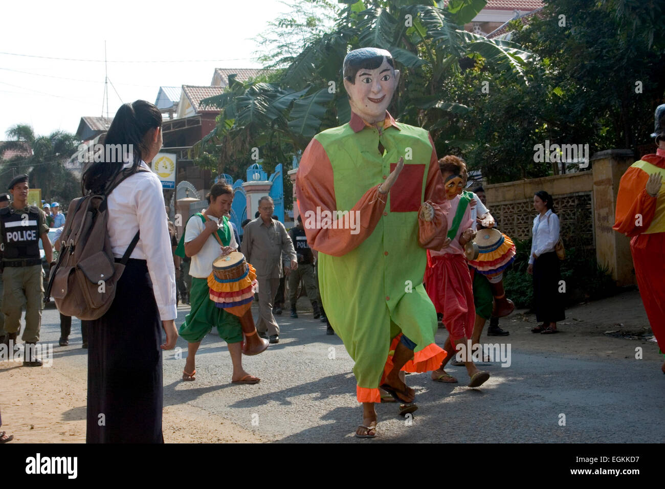 A man wearing a traditional Khmer costume is marching in a parade on a ...