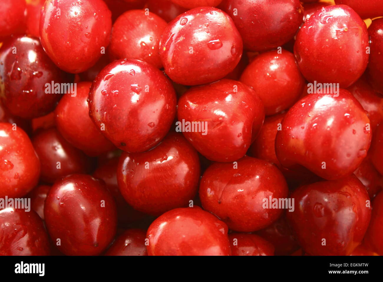 bunch of red cherry without the stem attached Stock Photo - Alamy
