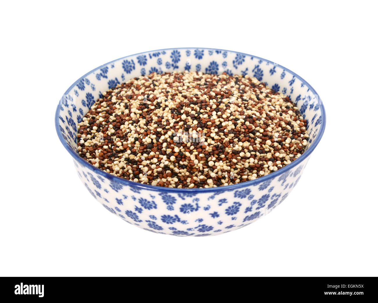 Mixed red, white and black quinoa in a blue and white porcelain bowl ...