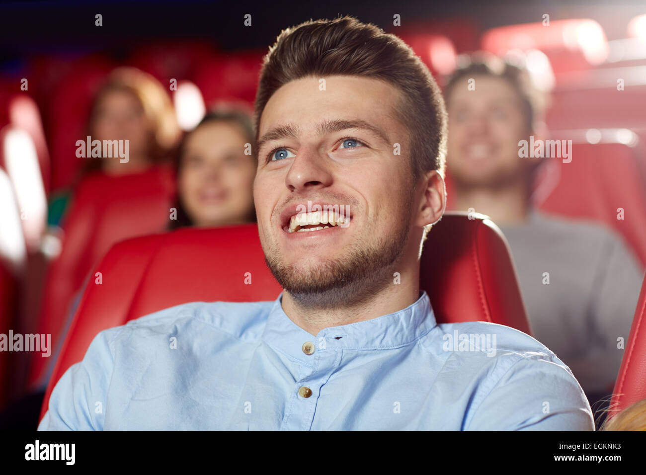 happy young man watching movie in theater Stock Photo - Alamy