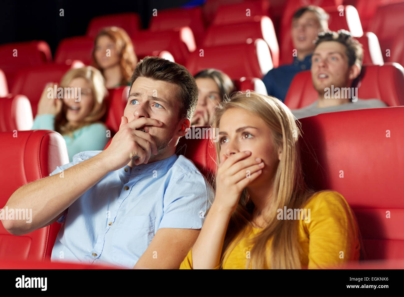 happy friends watching horror movie in theater Stock Photo - Alamy