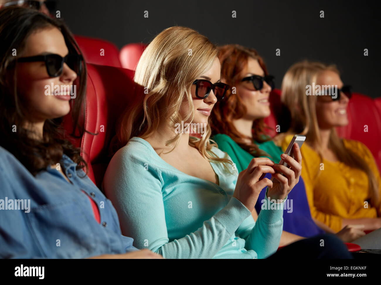 happy woman with smartphone in 3d movie theater Stock Photo - Alamy