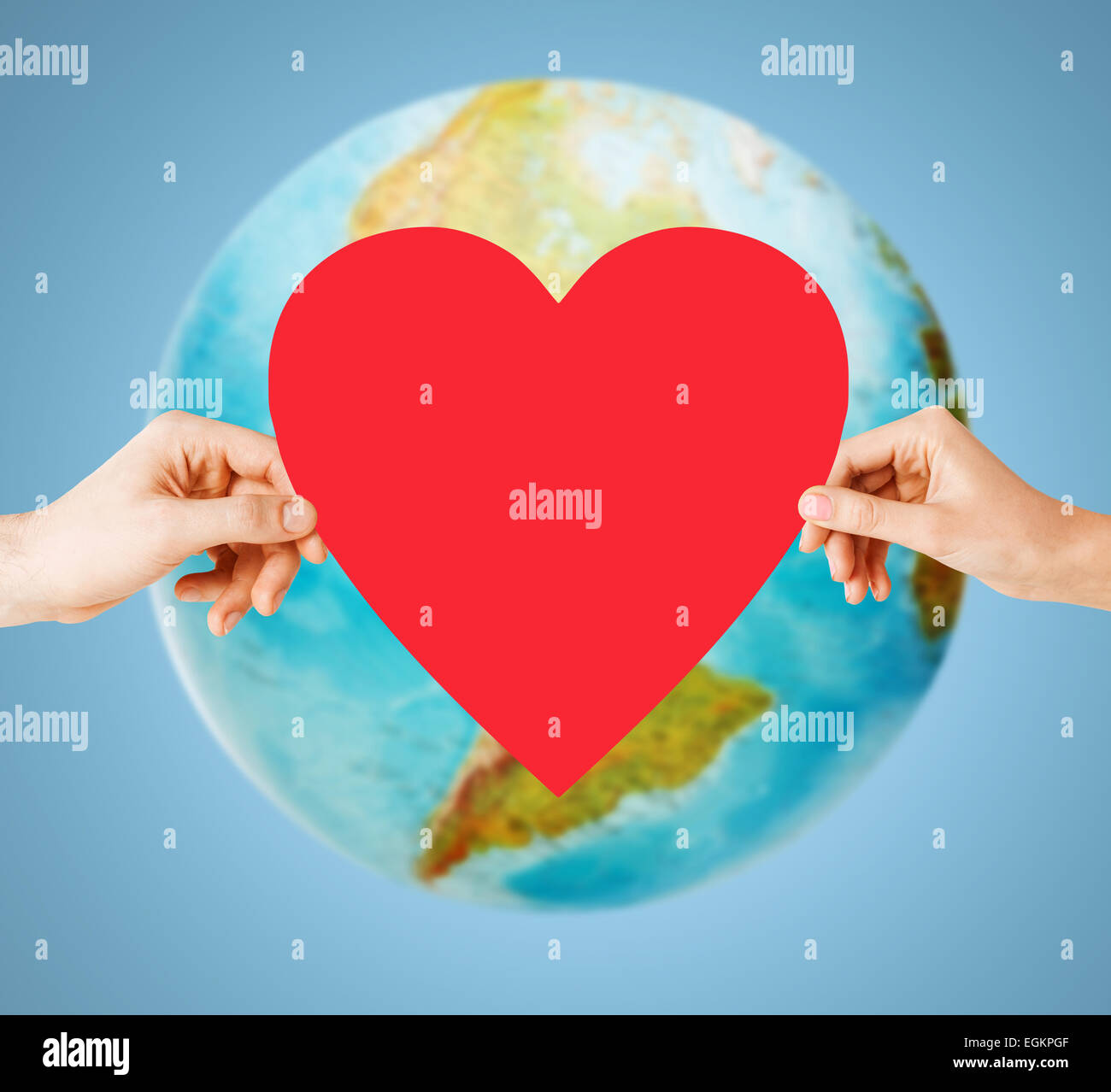 human hands holding red heart over earth globe Stock Photo - Alamy
