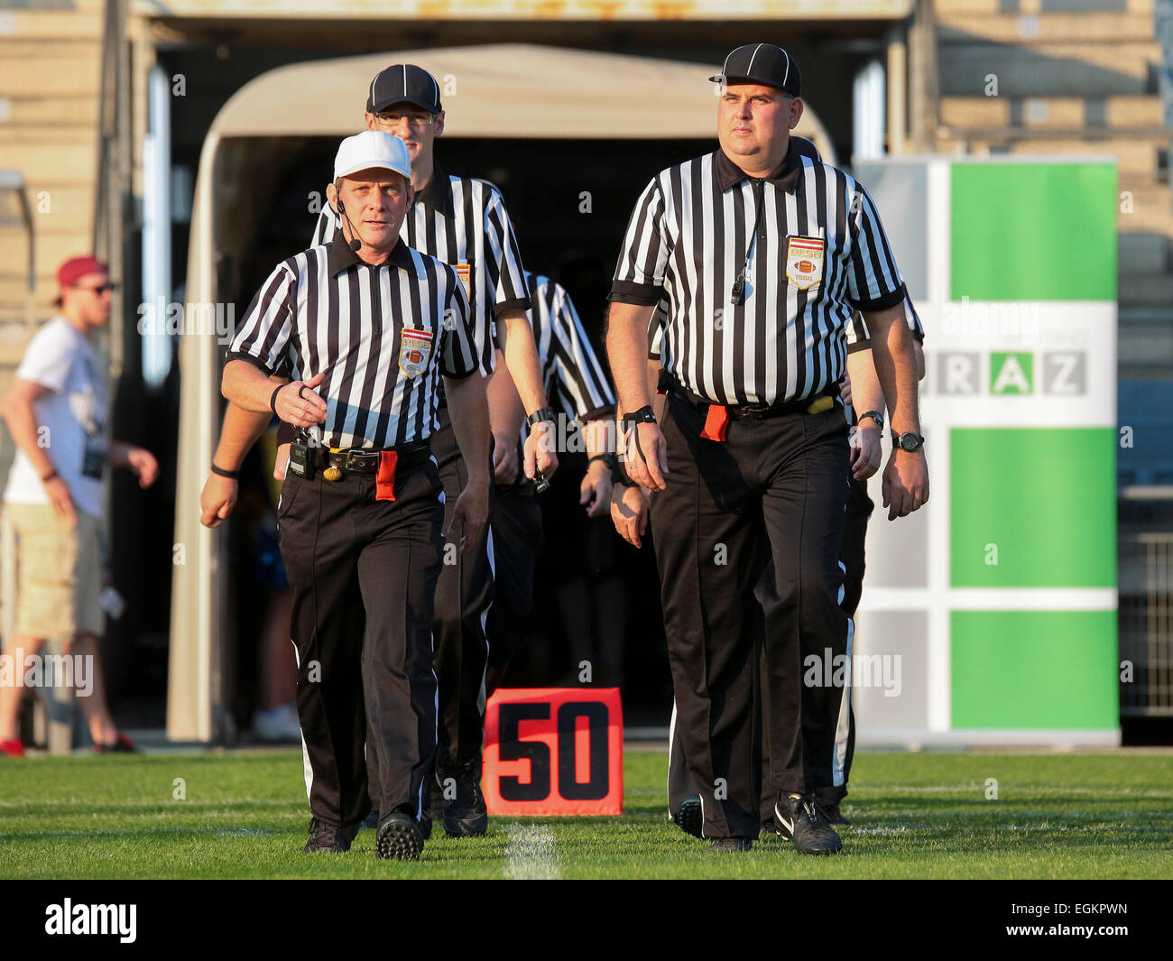 GRAZ, AUSTRIA - JUNE 27, 2014: The referee crew led by head referee ...