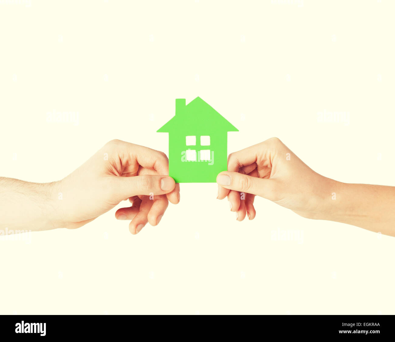 couple hands holding green house Stock Photo - Alamy