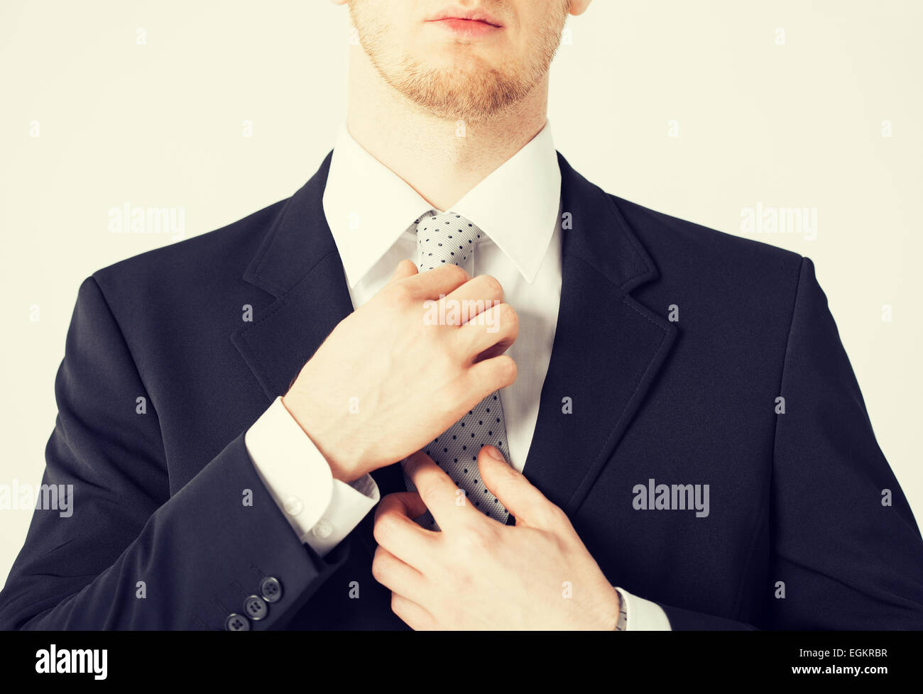 man adjusting his tie Stock Photo - Alamy