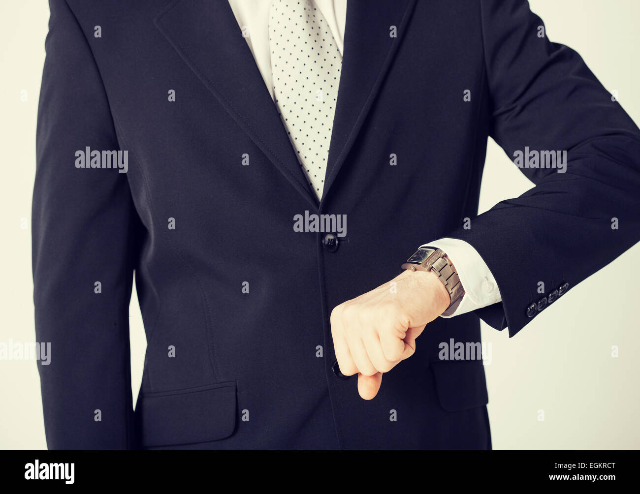 man looking at wristwatch Stock Photo - Alamy